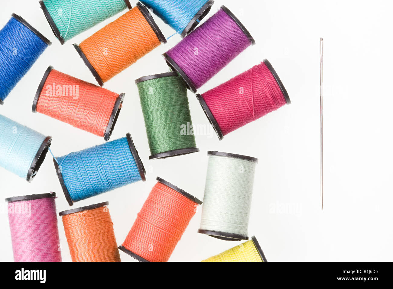 A needle and cotton reels Stock Photo - Alamy