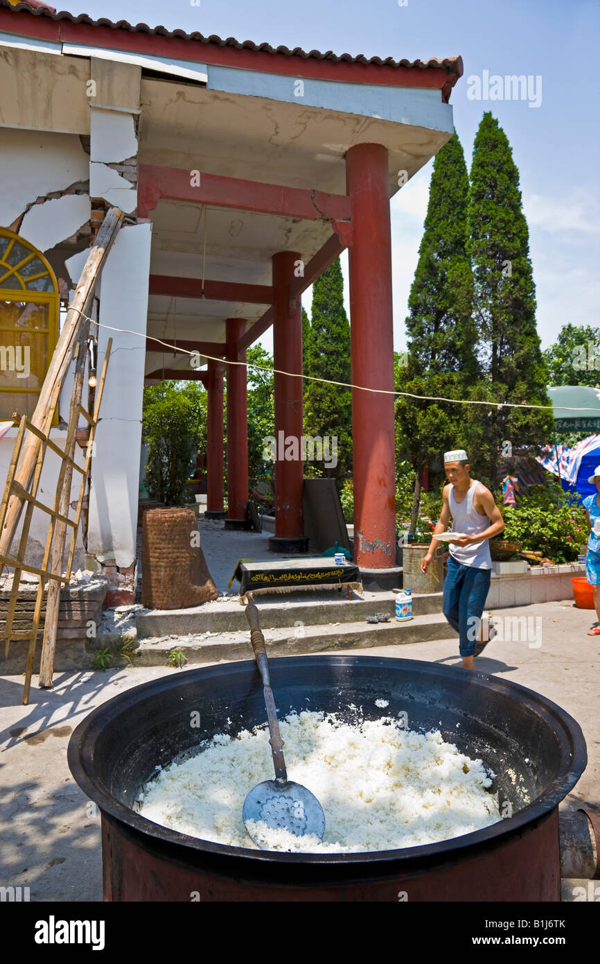 Rice cooking outside earthquake severely damaged mosque in Luoshui ...