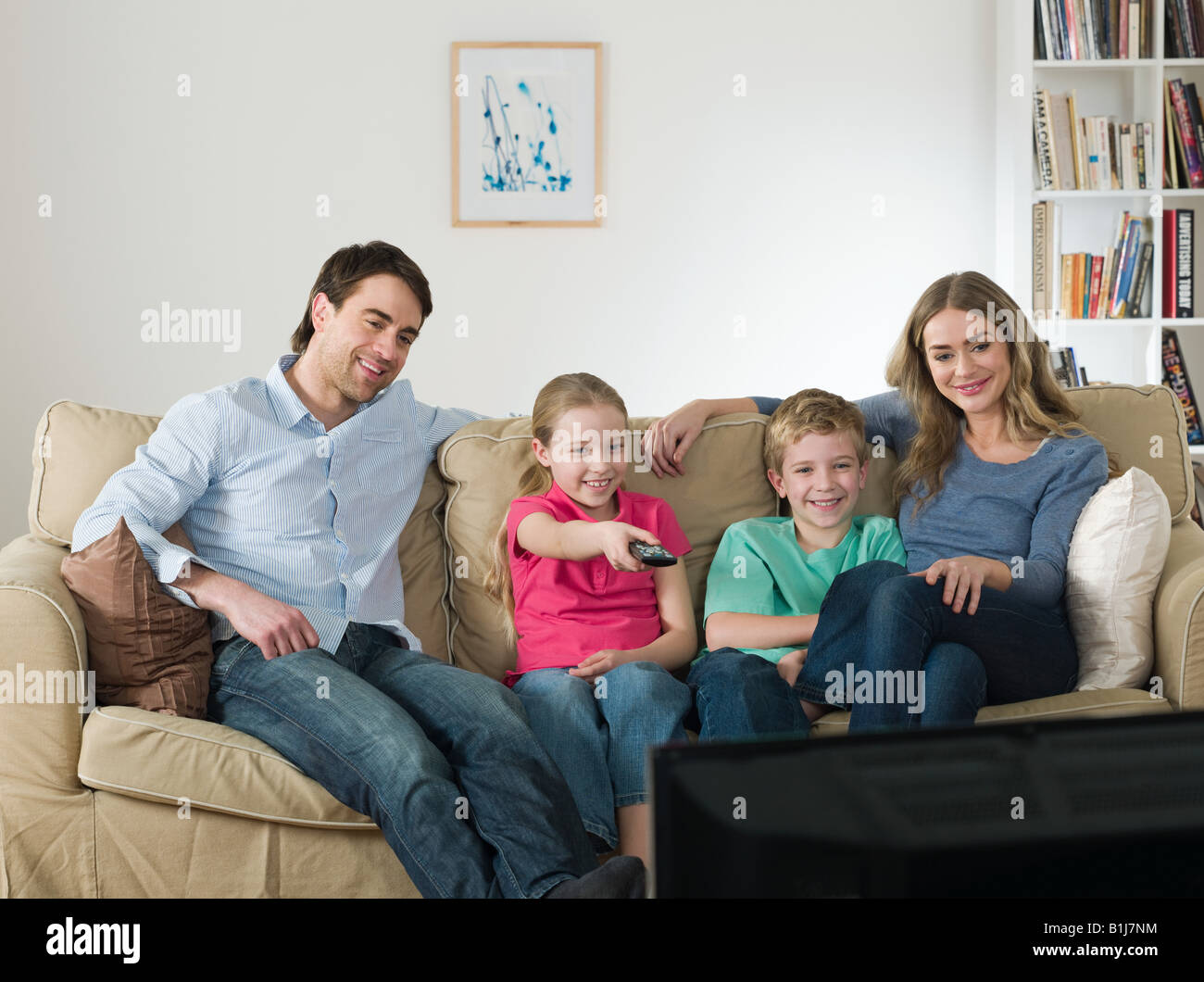 A family watching tv Stock Photo - Alamy
