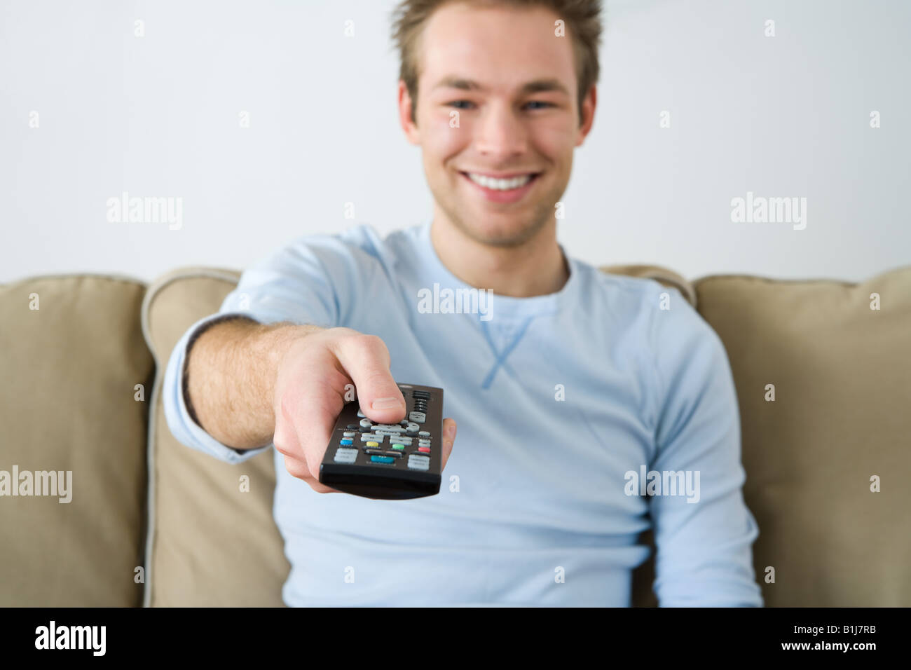 A young man watching tv Stock Photo - Alamy
