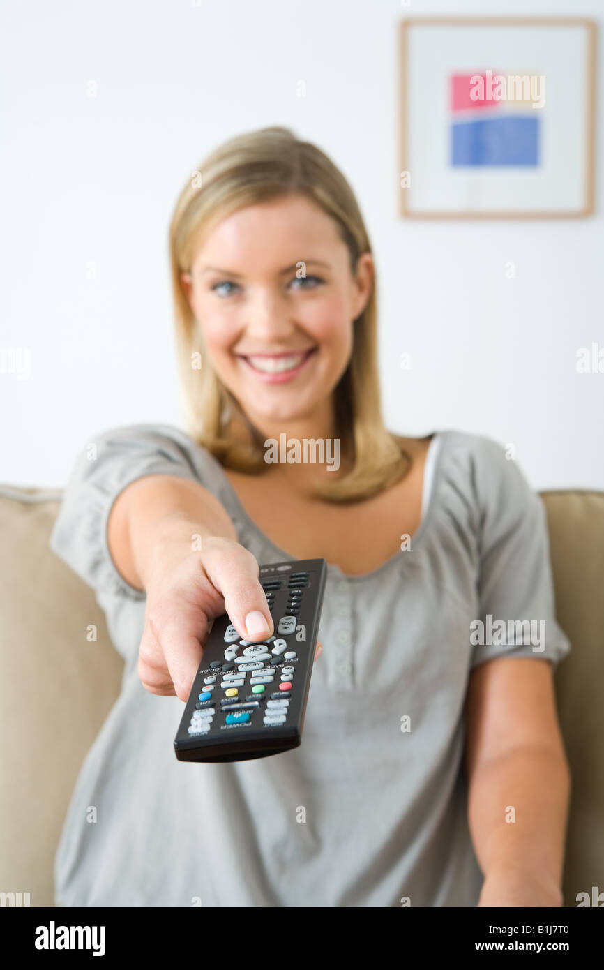 A young woman watching tv Stock Photo - Alamy