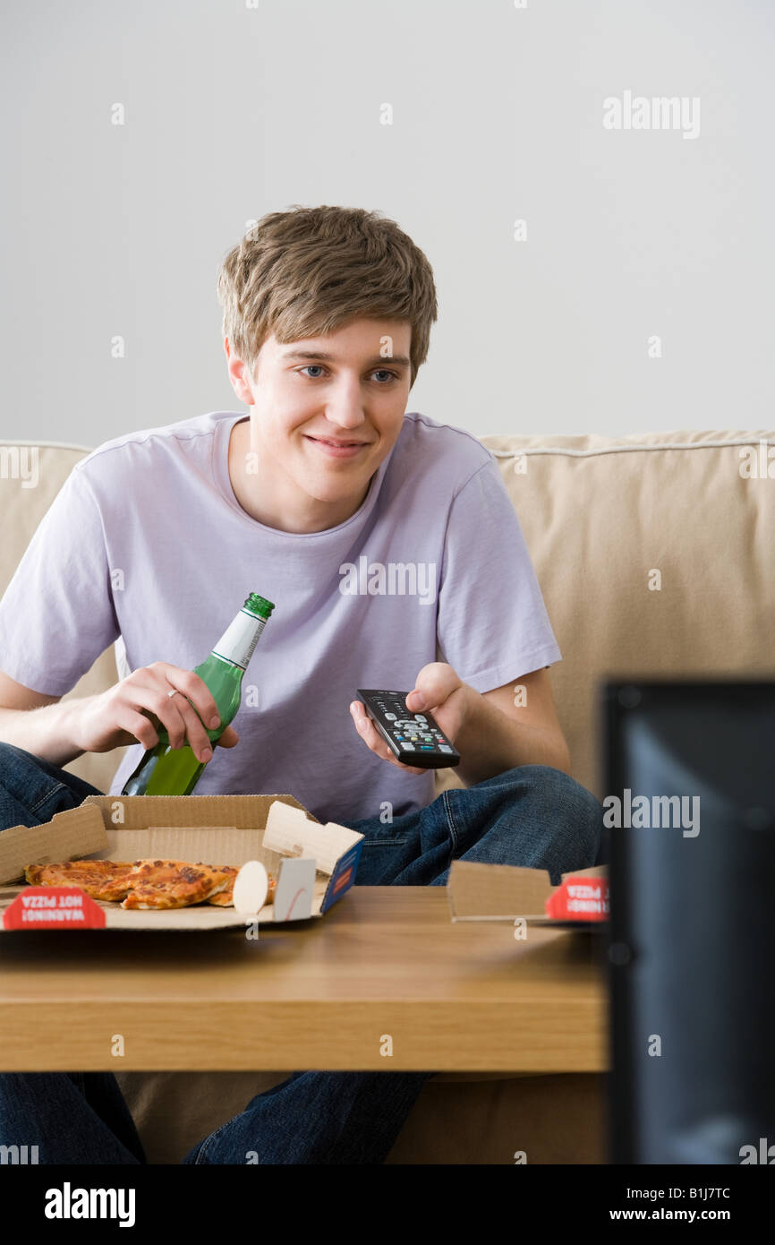 A young man watching tv Stock Photo - Alamy