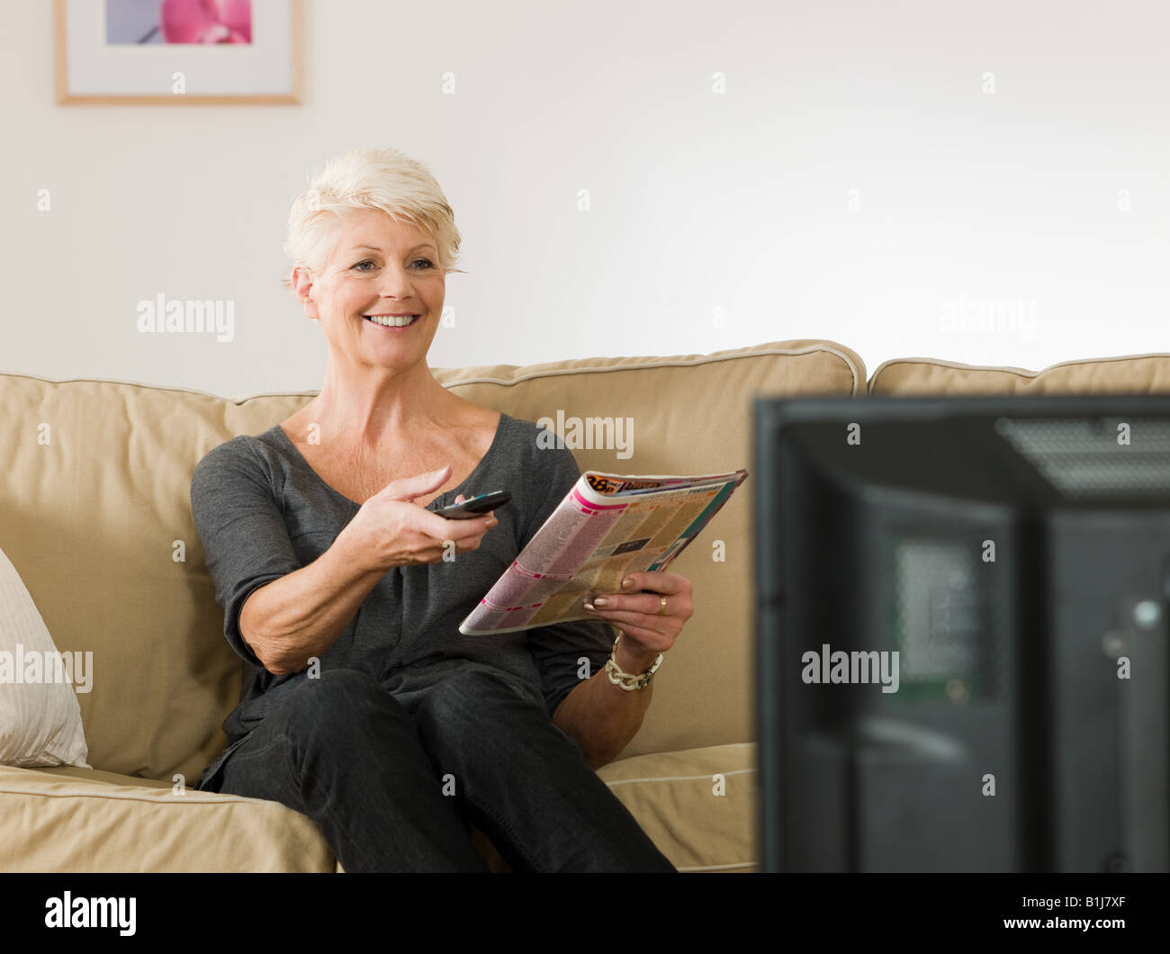 A senior woman watching tv Stock Photo - Alamy
