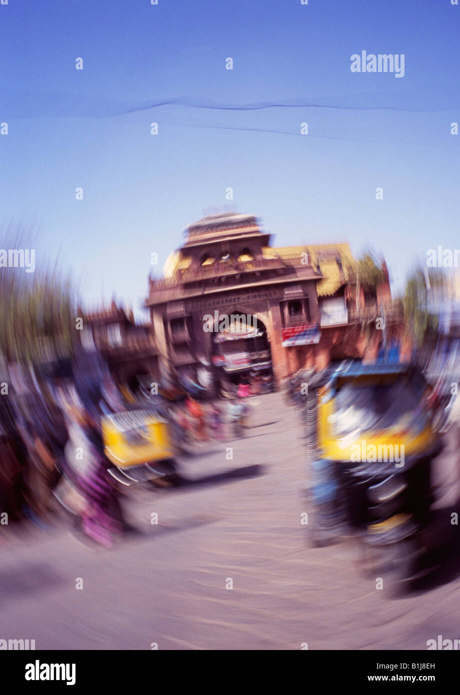rickshaw driving through Indian street scene Stock Photo - Alamy