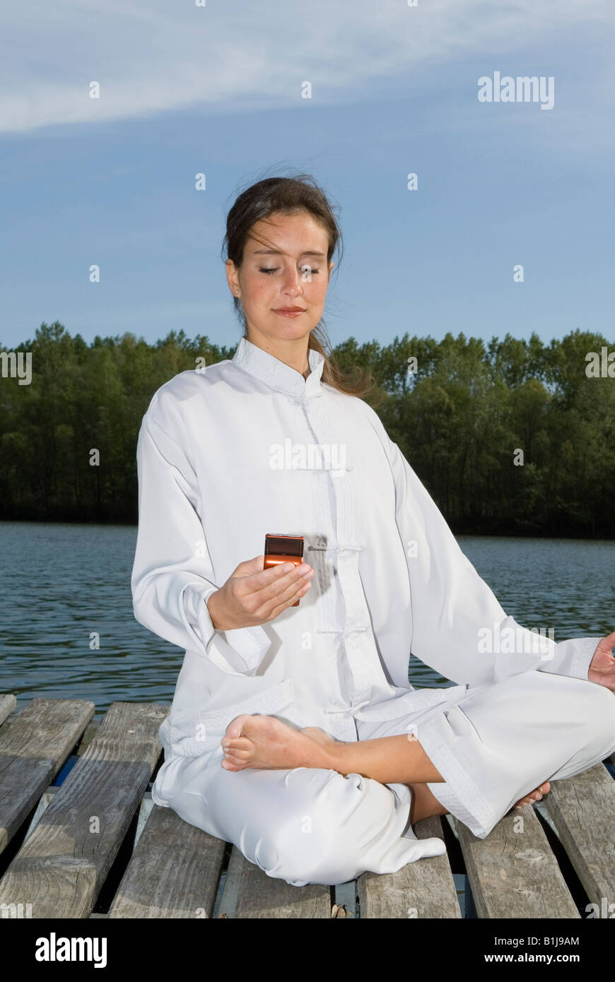 Woman practising Yoga, half lotus pose, Ardha Padmasana, Mudra and ...