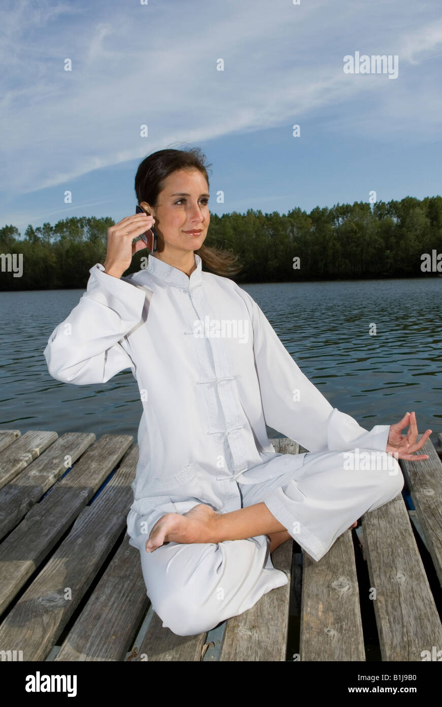 Woman practising Yoga, half lotus pose, Ardha Padmasana, Mudra and ...