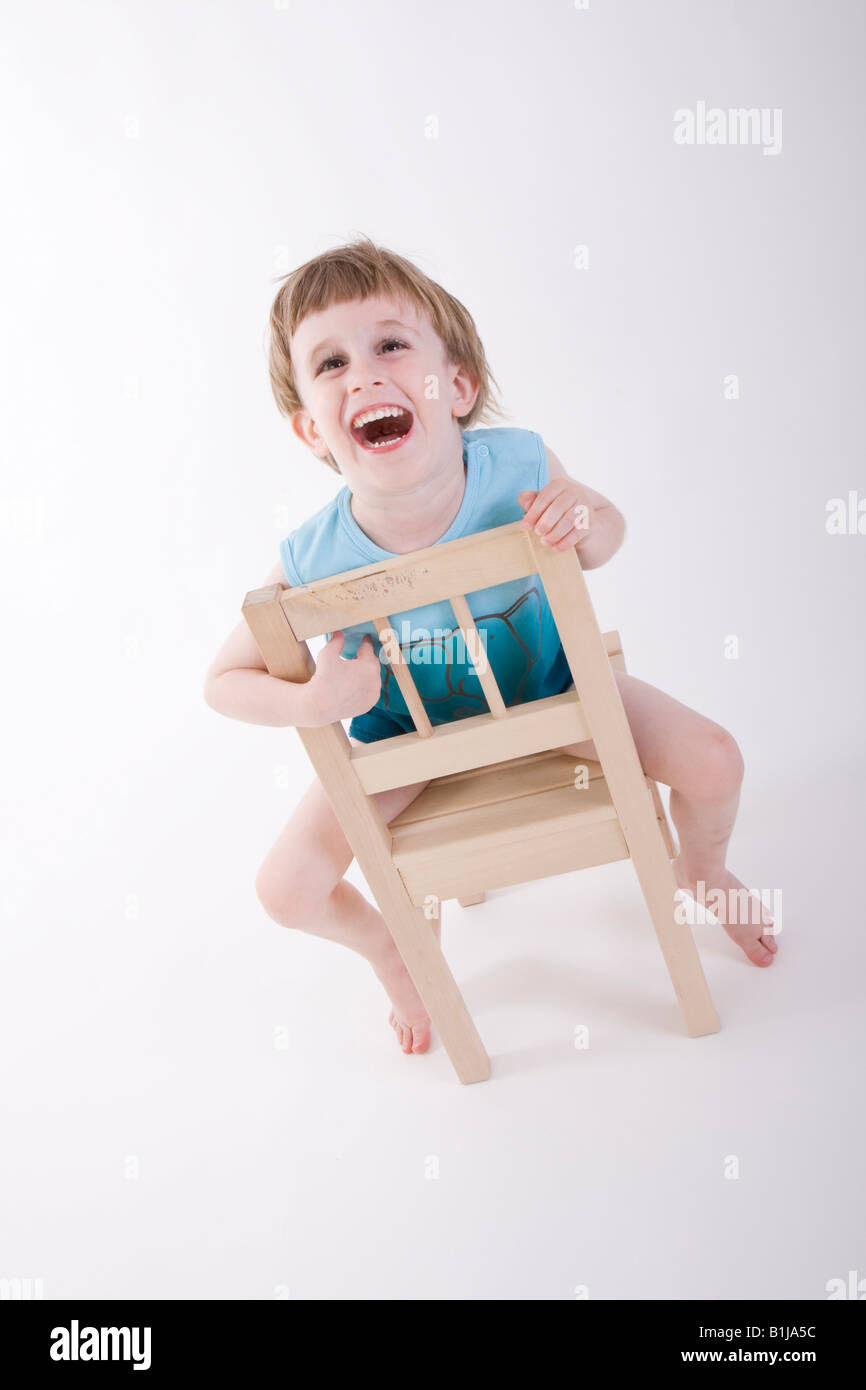little boy sitting on a chair Stock Photo - Alamy
