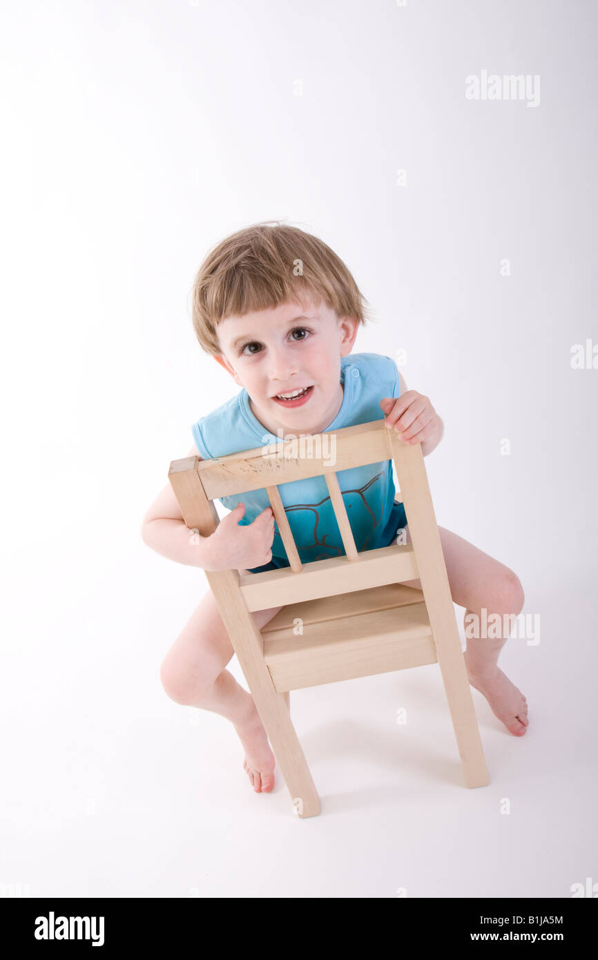 little boy sitting on a chair Stock Photo - Alamy