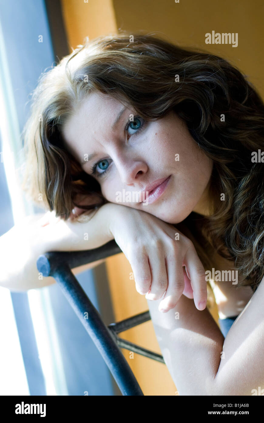 young, beautiful woman with long curly hair, absent-minded Stock Photo ...