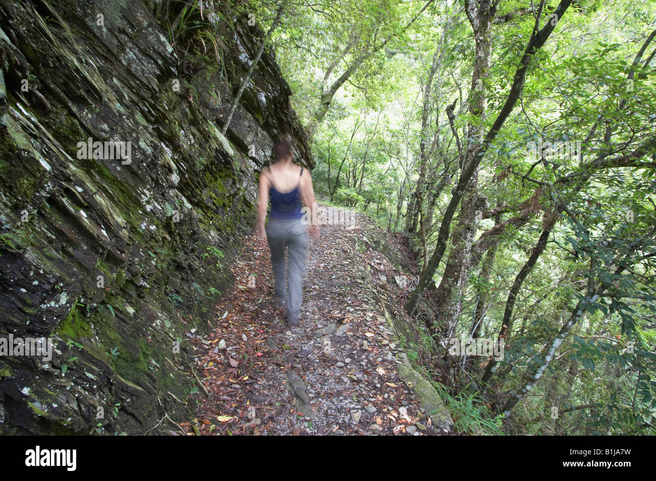 Chinese Woman Walking Along Hiking Trail In Mountains Stock Photo - Alamy