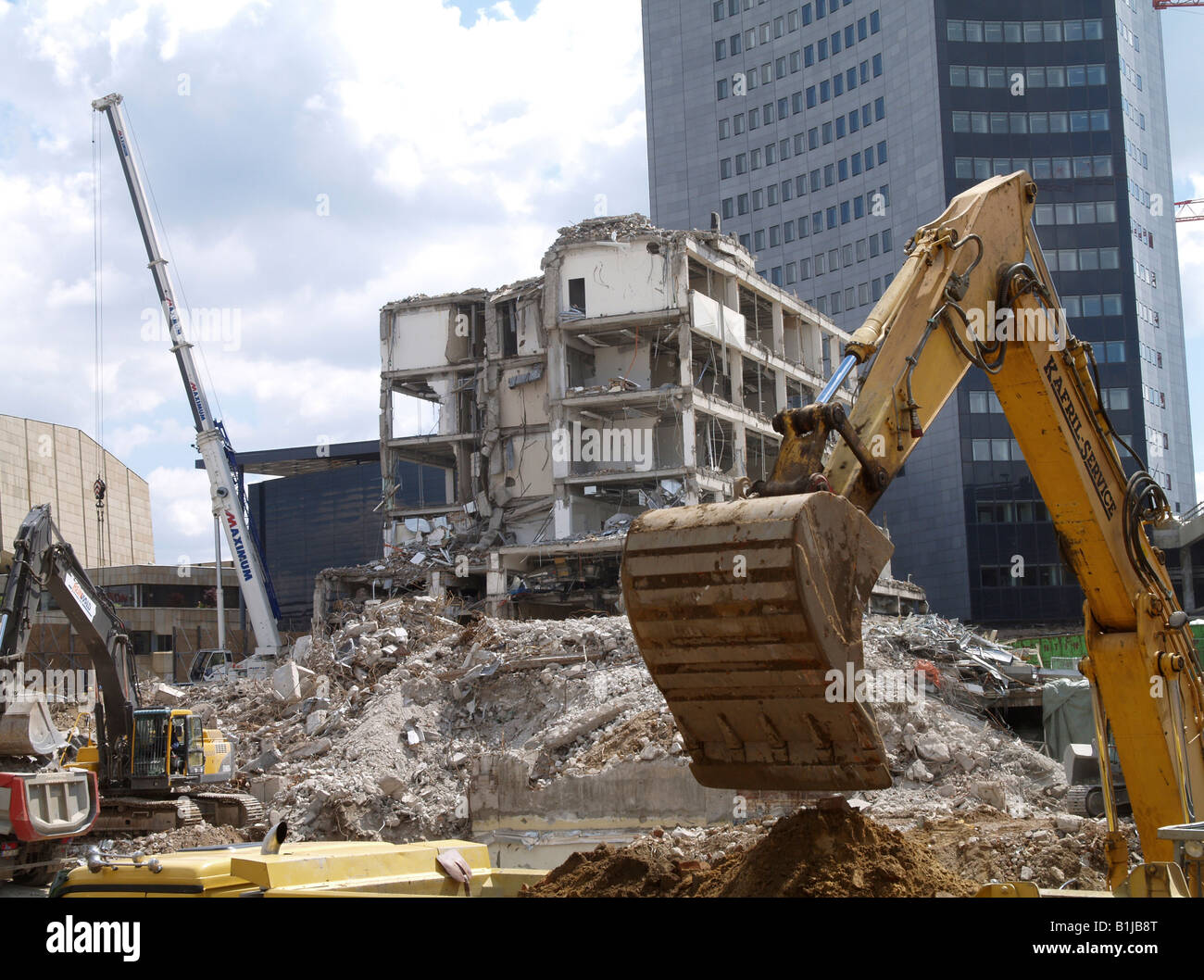 cranes and excavators at a construction site. Demolition of old houses ...