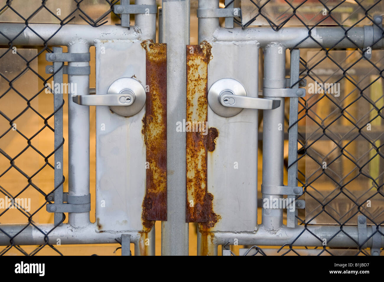 locked Gate handles on a fence entrance in front of a retail store ...