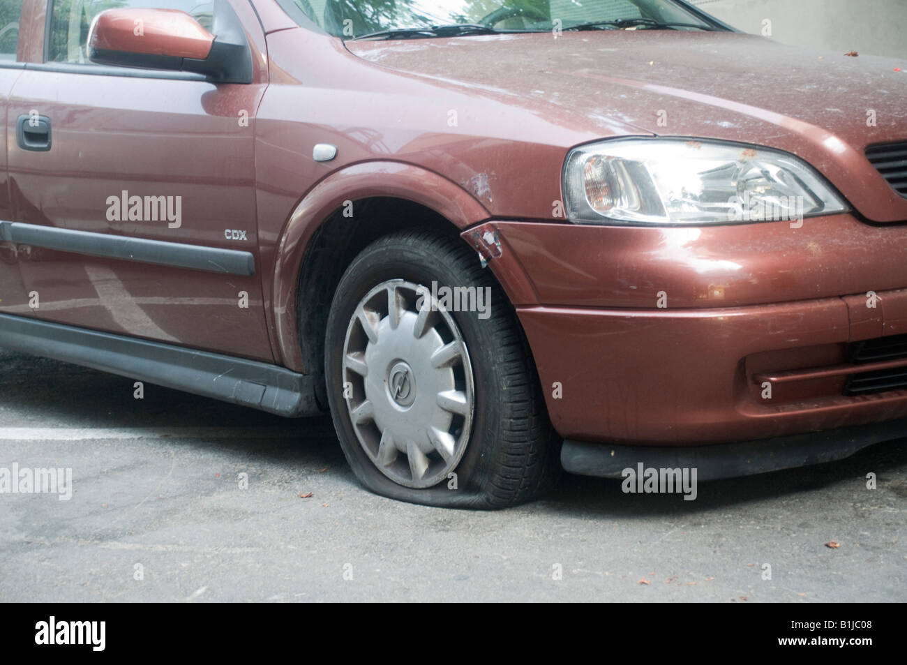 Punctured Car Tyre Stock Photos & Punctured Car Tyre Stock Images - Alamy