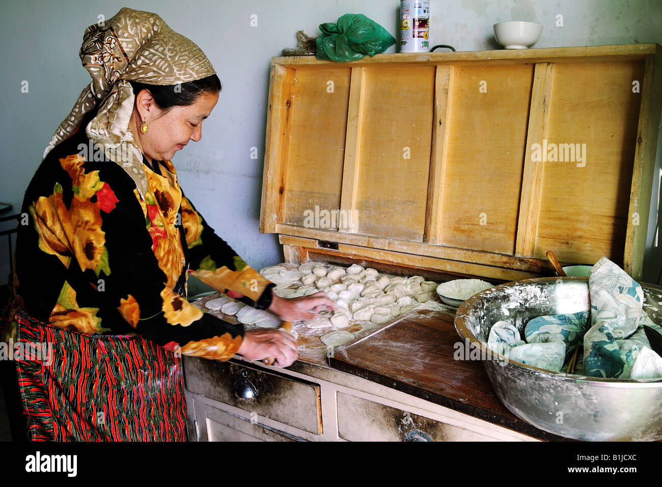 A Uyger woman prepares fresh dumplings for breakfast in Xinjiang China ...