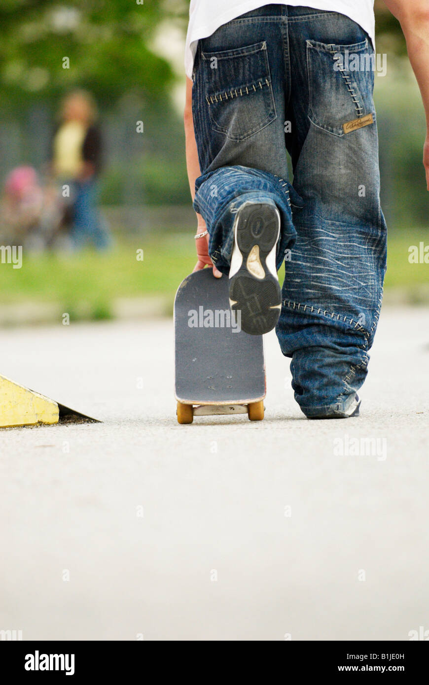 back view of a skater with a skateboard Stock Photo - Alamy