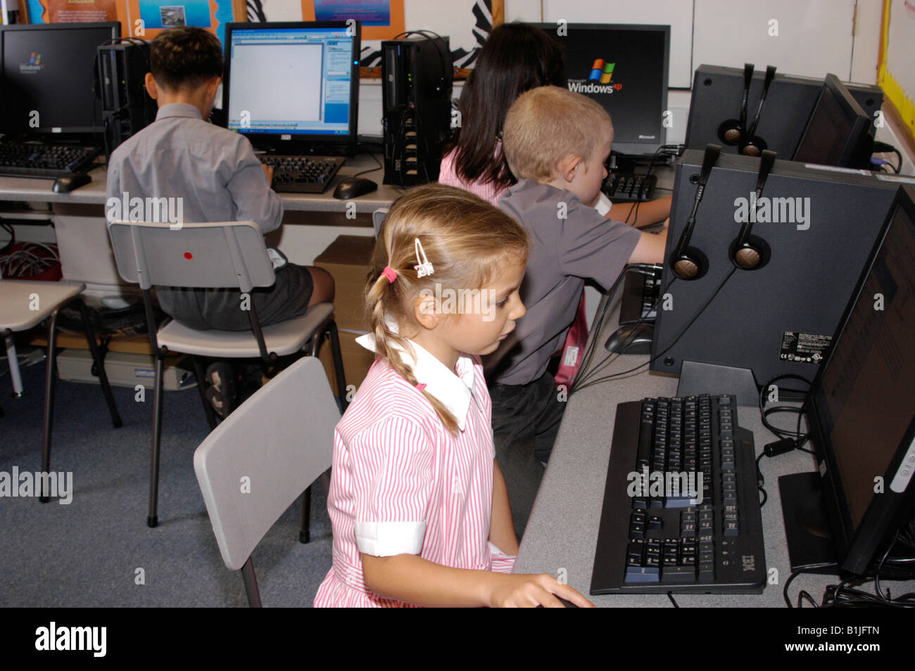 children in school learning on computers Stock Photo - Alamy
