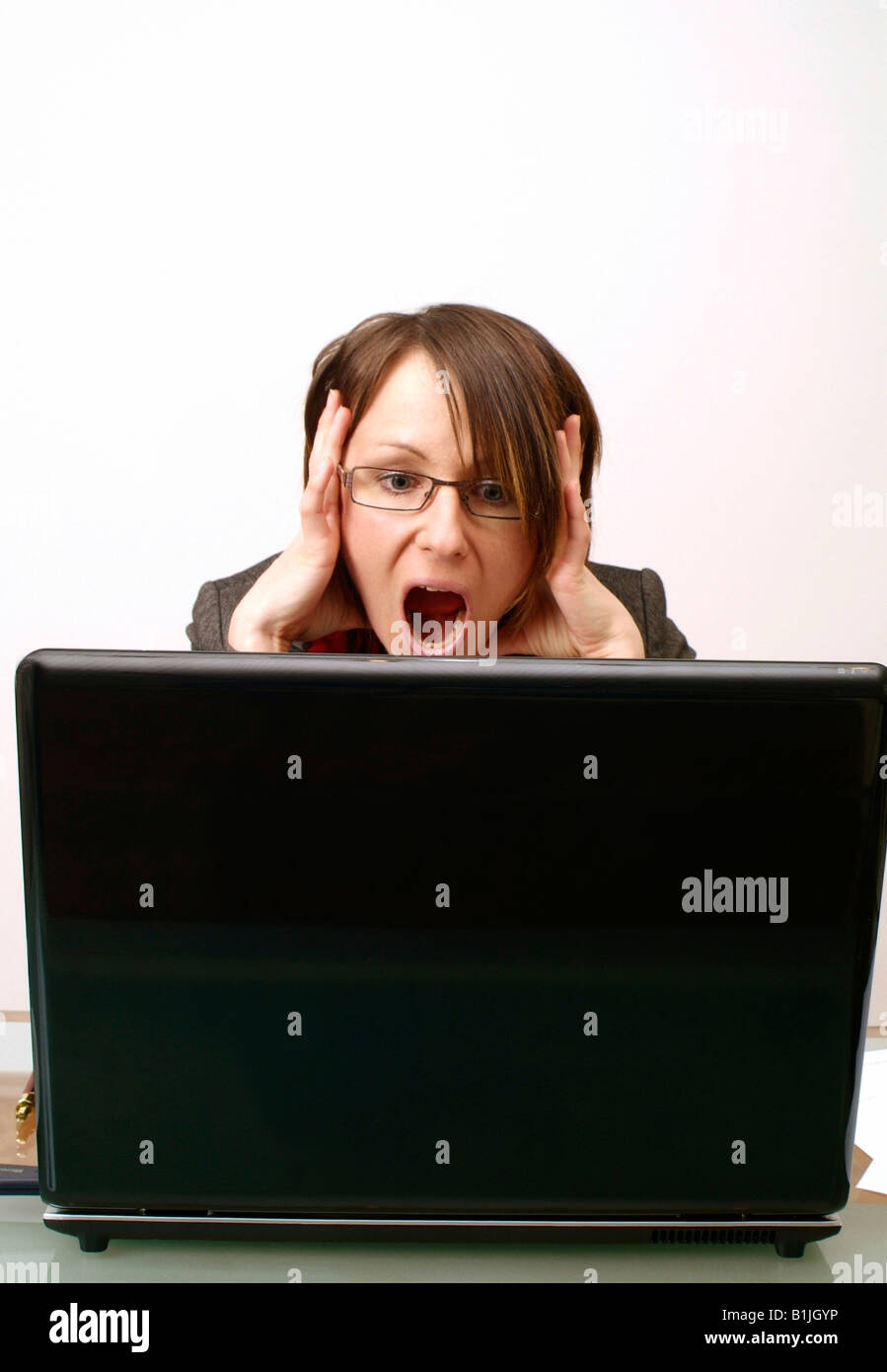 young businesswoman in panic using laptop Stock Photo - Alamy young businesswoman in panic using laptop Stock Photo - Alamy
