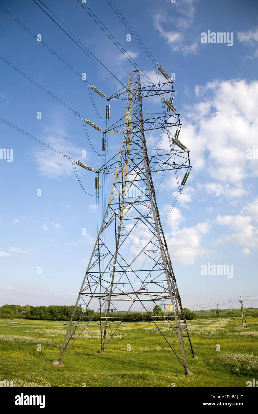 A typical countryside scene from England. A powerline is held up by a ...