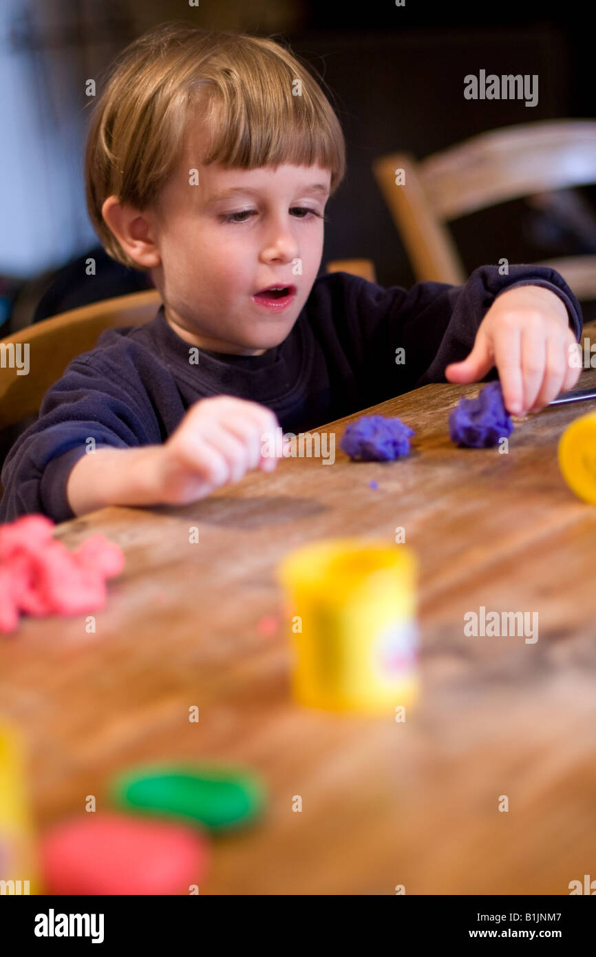 little boy playing with play dough Stock Photo - Alamy