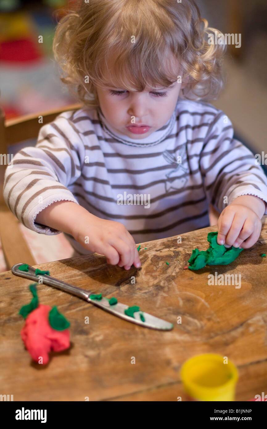 little girl playing with play dough Stock Photo - Alamy