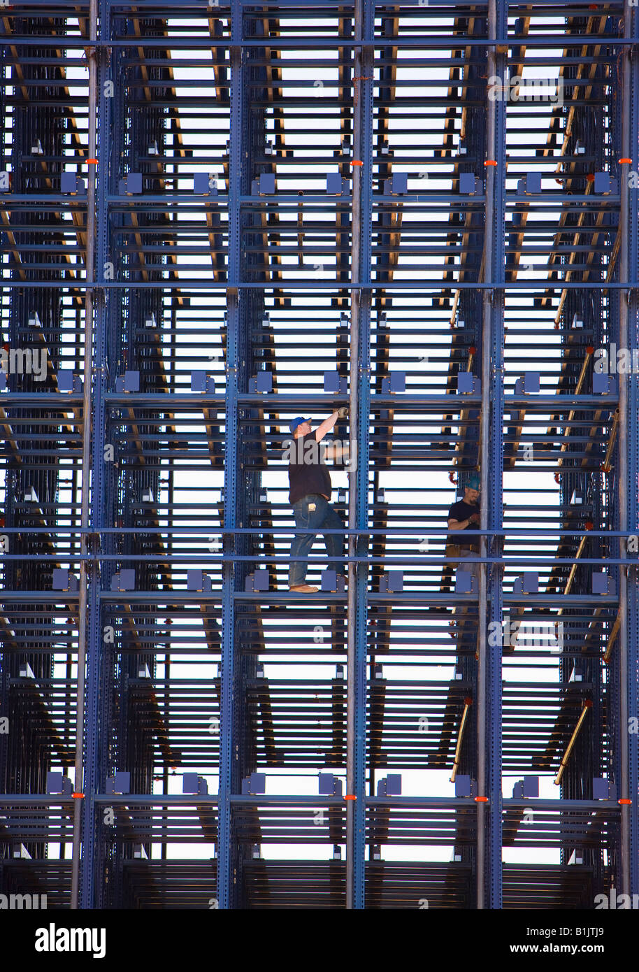 A steel worker climbs along the steel beams at a construction site ...