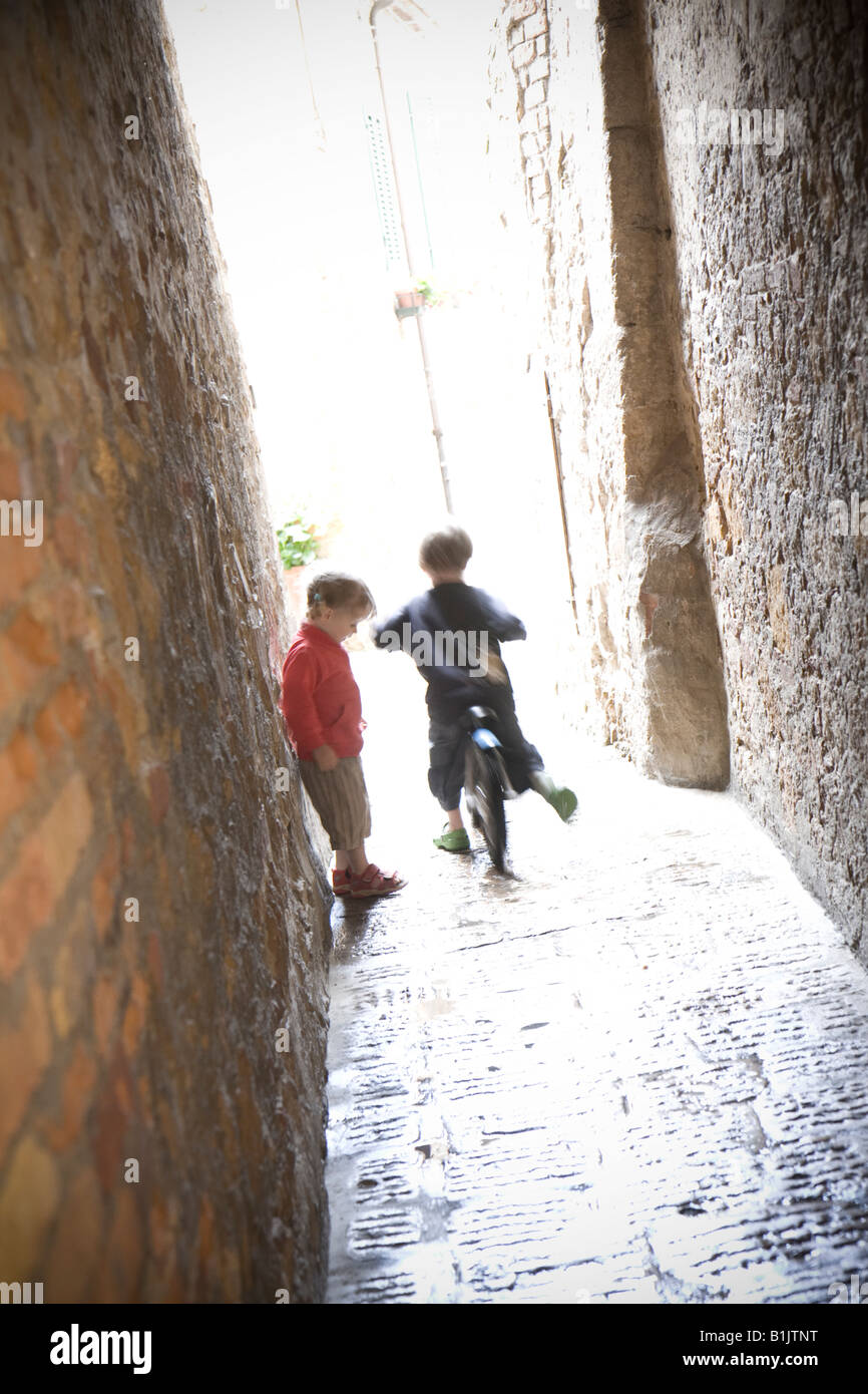 children playing in narrow street Stock Photo - Alamy