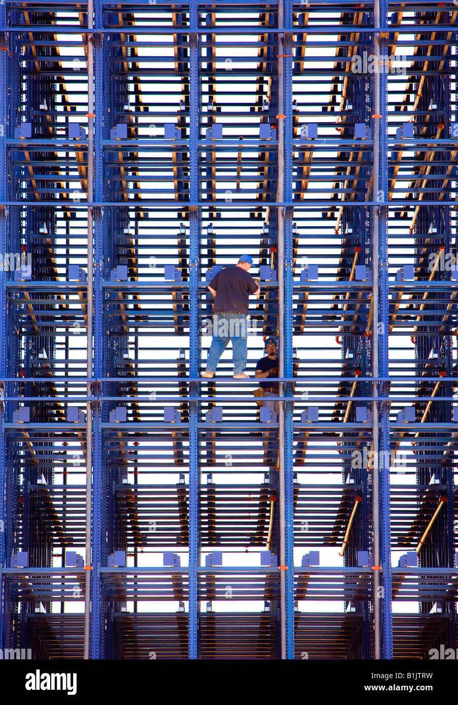 A steel worker climbs along the steel beams at a construction site ...