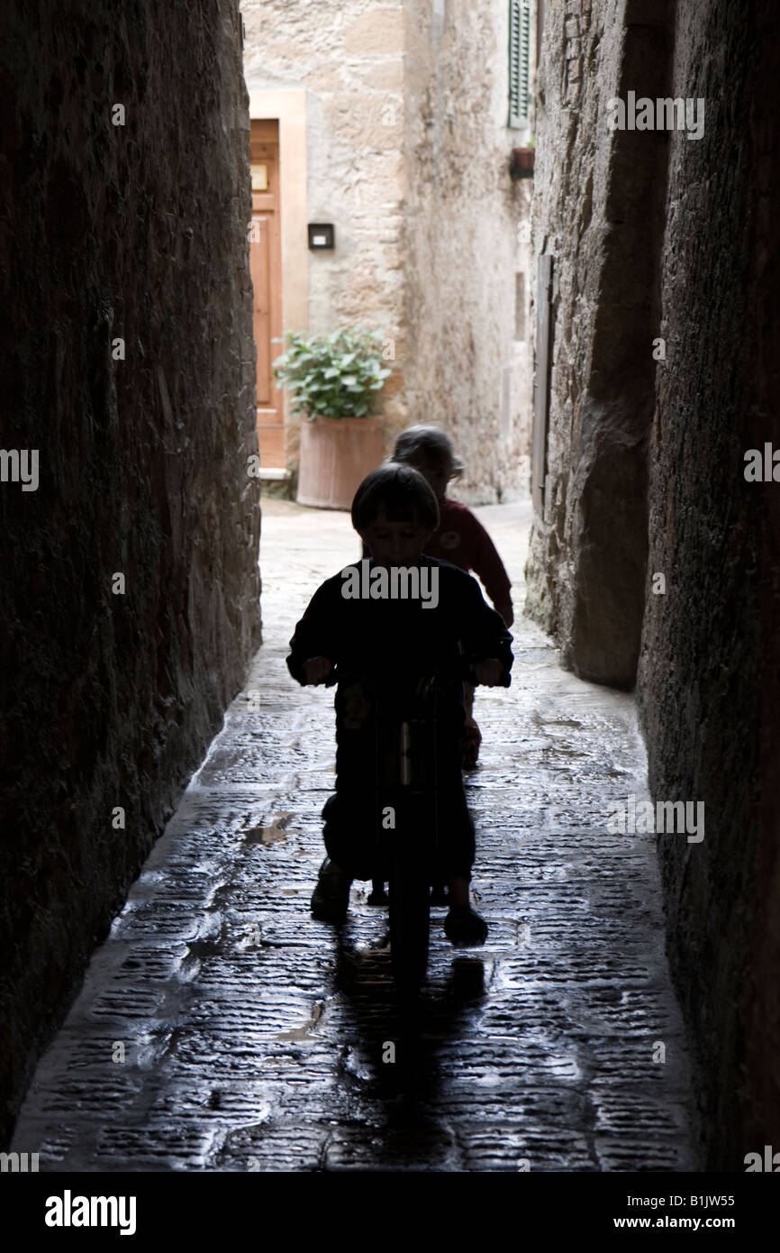 children playing in narrow street Stock Photo - Alamy