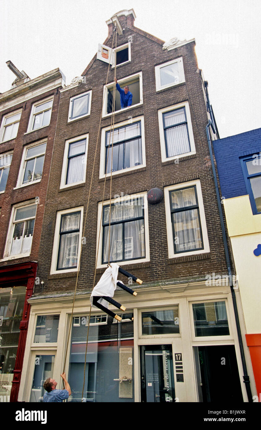 europe holland amsterdam hoisting up a table into a house Stock Photo ...