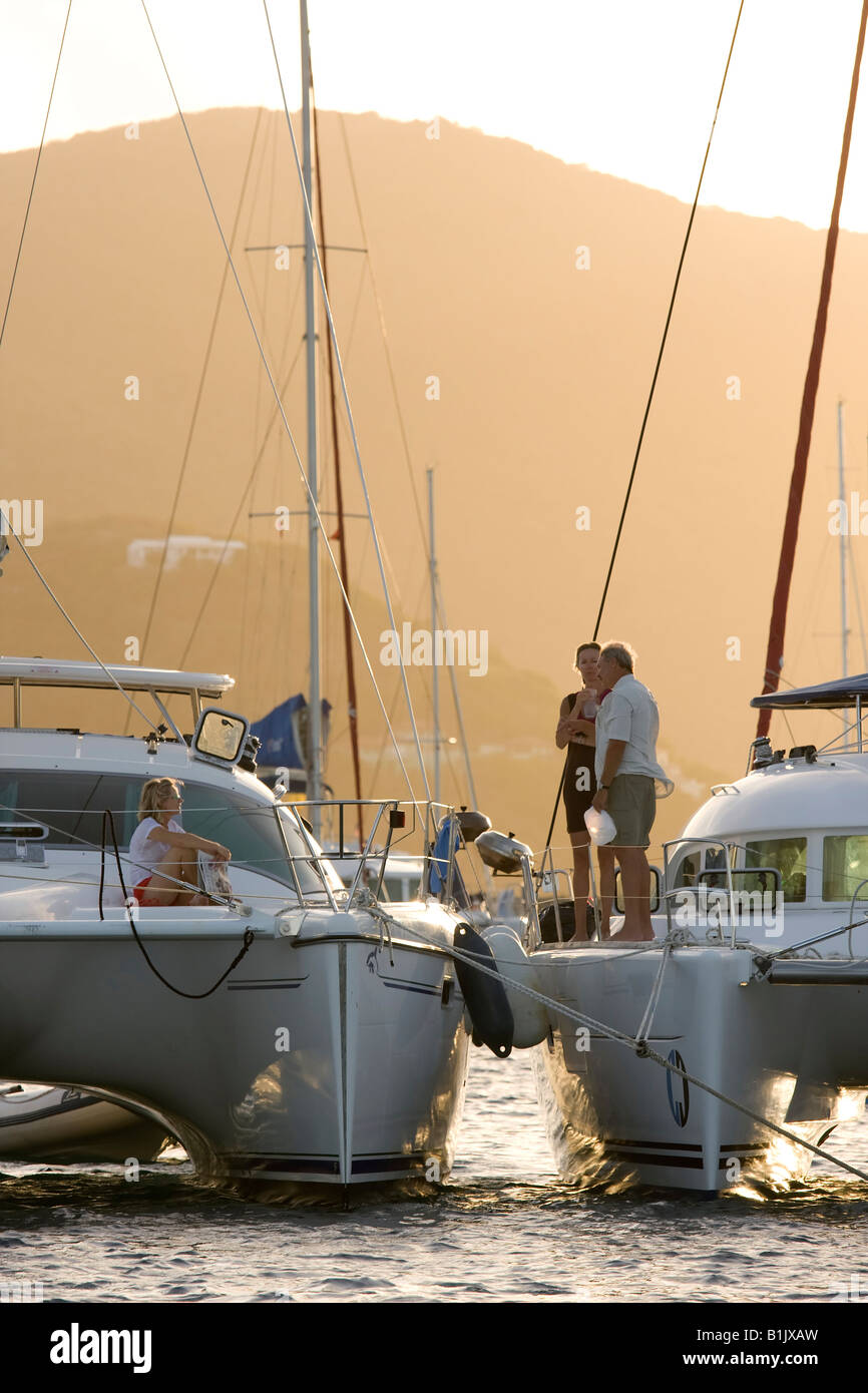 couple on deck of moored catamaran in the evening Stock Photo - Alamy