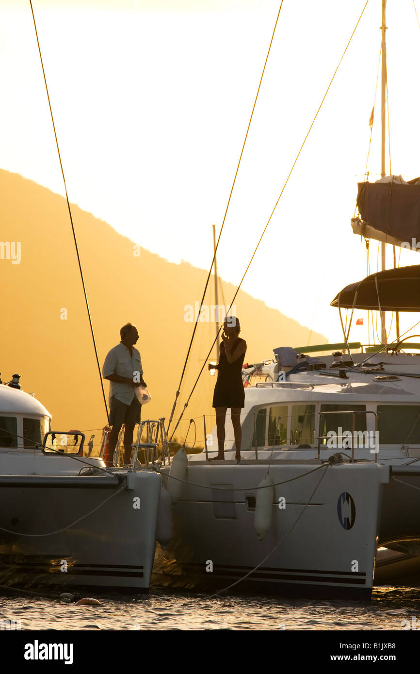 couple on deck of moored catamaran in the evening Stock Photo - Alamy