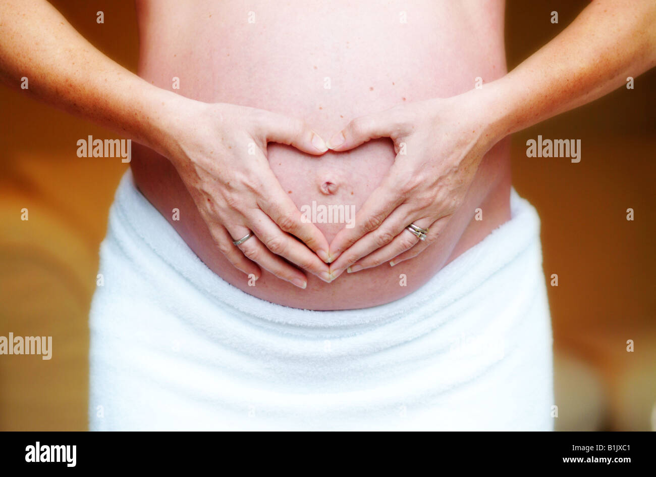 pregnant woman heart shaped hands baby bump tummy belly stomach ...