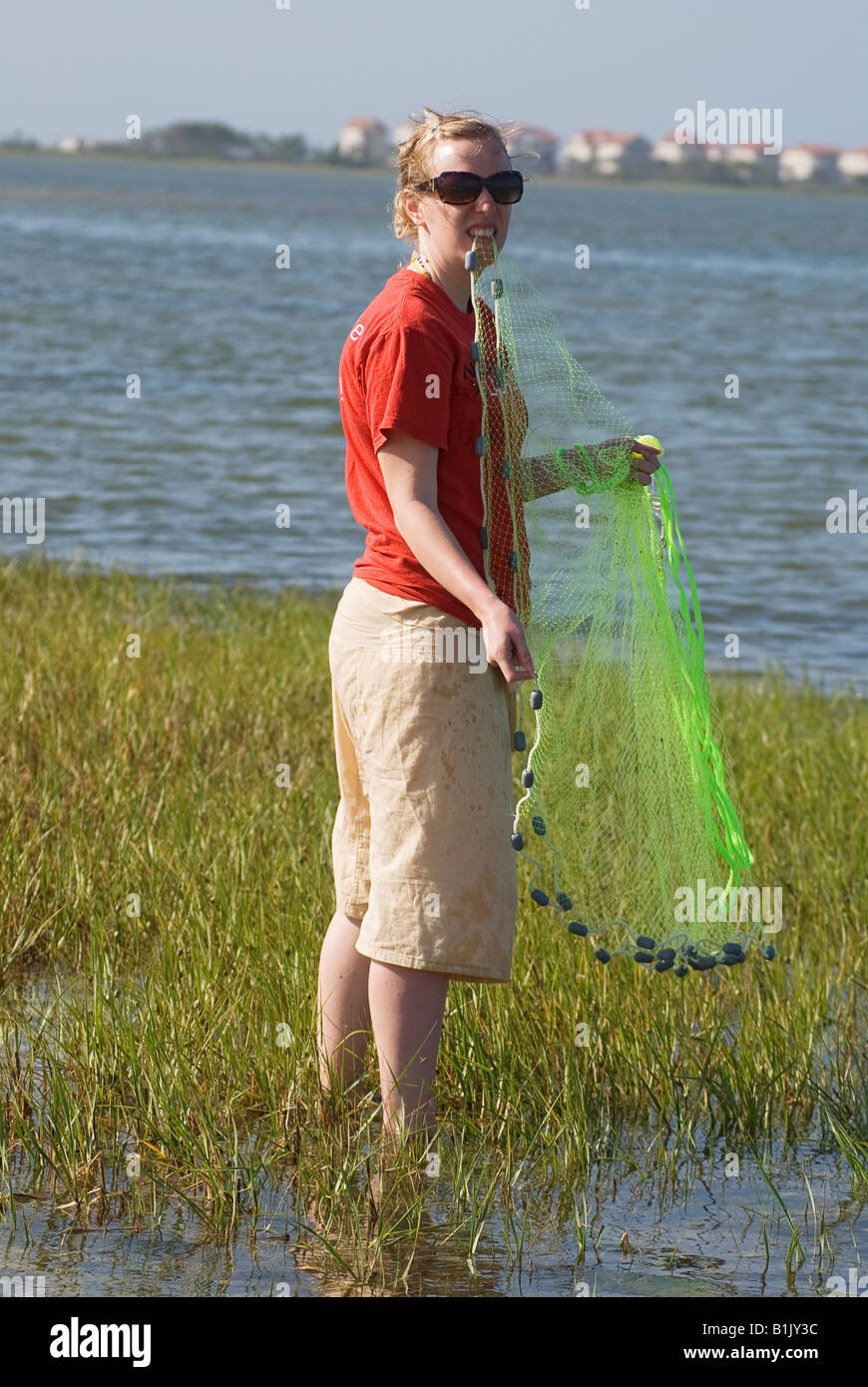kayakers learn to throw a cast net to catch fish along the bay side of ...