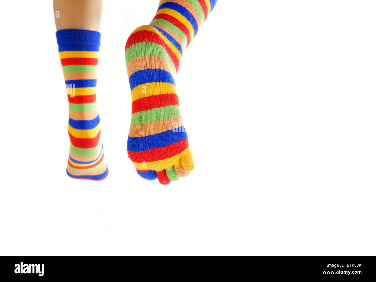 Close up photo of the legs in colored socks going away Stock Photo - Alamy