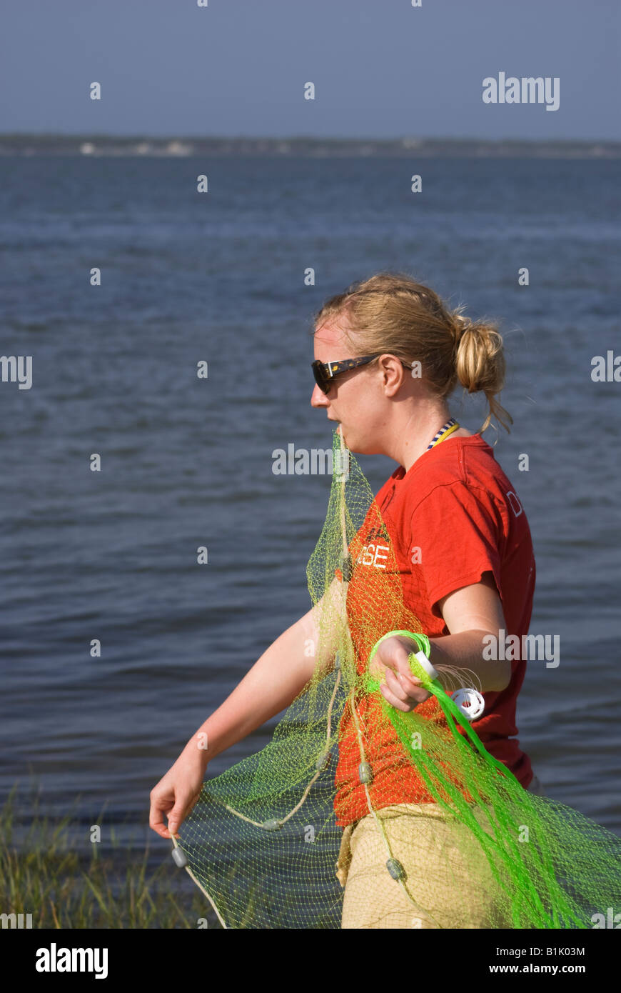 learning to throw a cast net to catch fish along the bay side of St ...