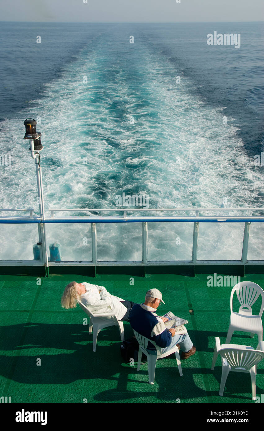 A couple relaxing on a channel ferry crossing Stock Photo - Alamy