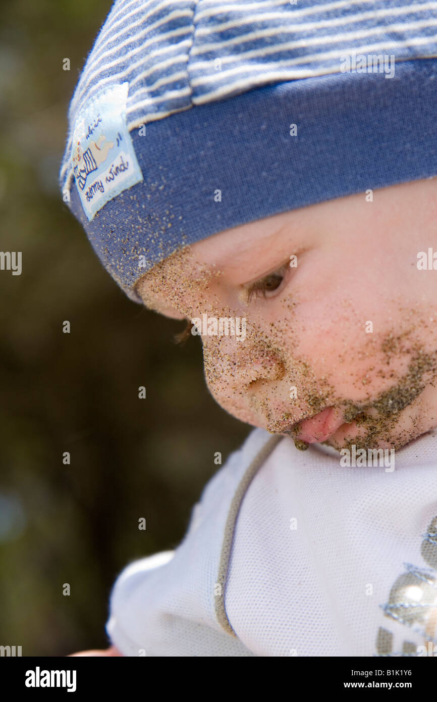 baby with sand in the face Stock Photo - Alamy