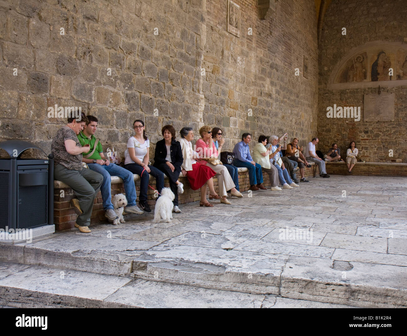 people sitting in line Stock Photo - Alamy