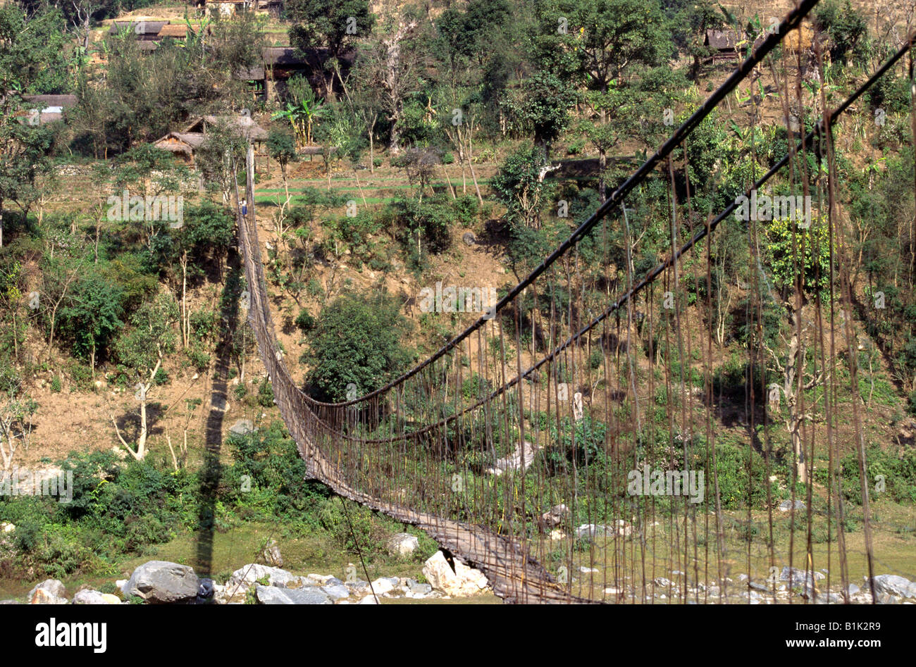 Nepal Central girl crossing Trisuli River by decrepit old rope bridge ...