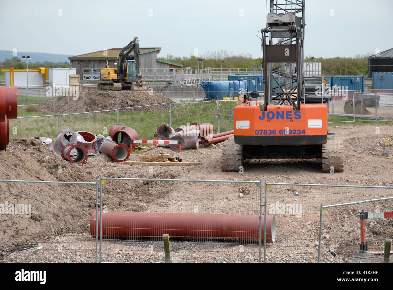 Construction site, building crane, digger, pipes, UK Stock Photo - Alamy