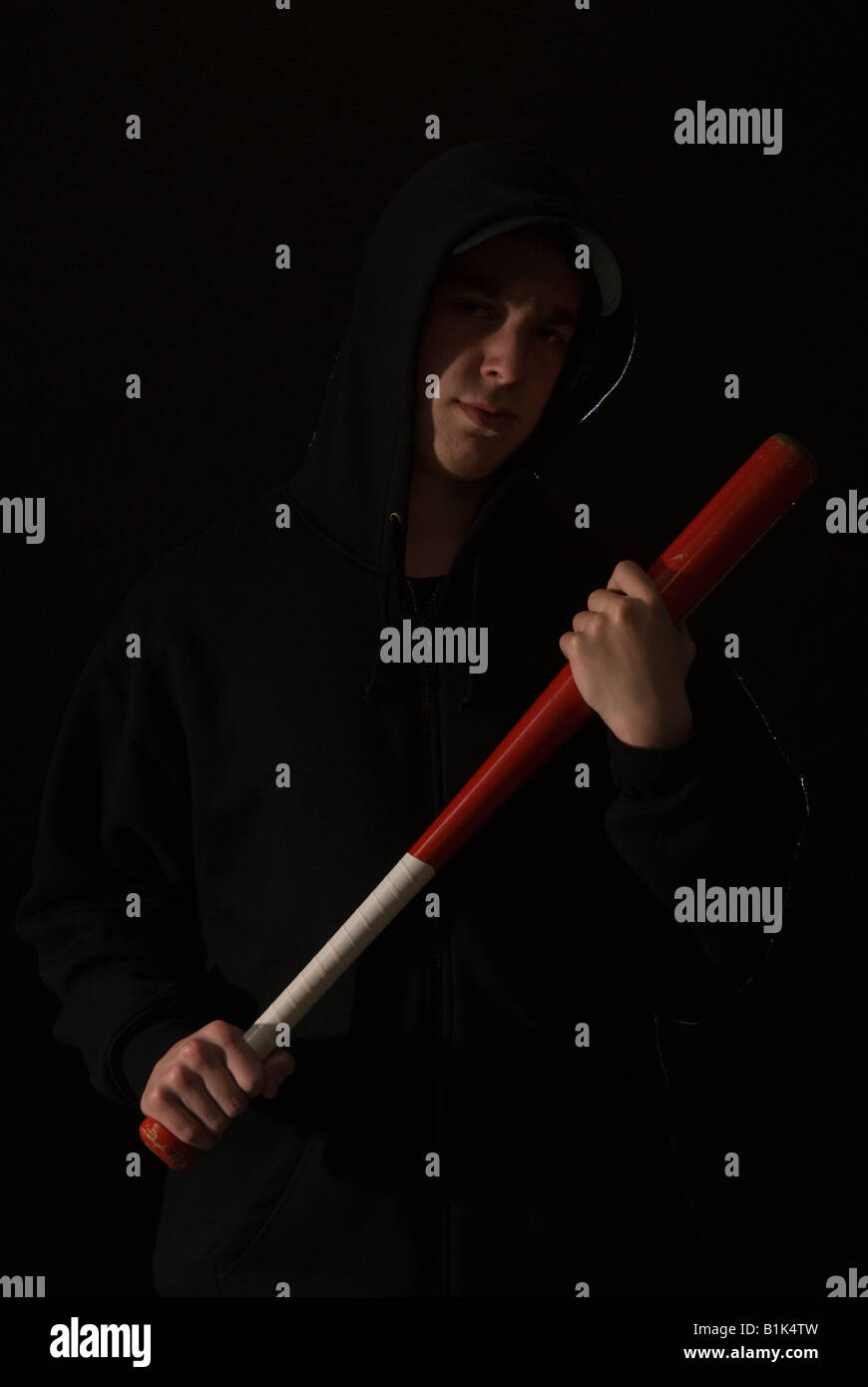 Hoody wearing teenage thug with baseball bat Stock Photo - Alamy