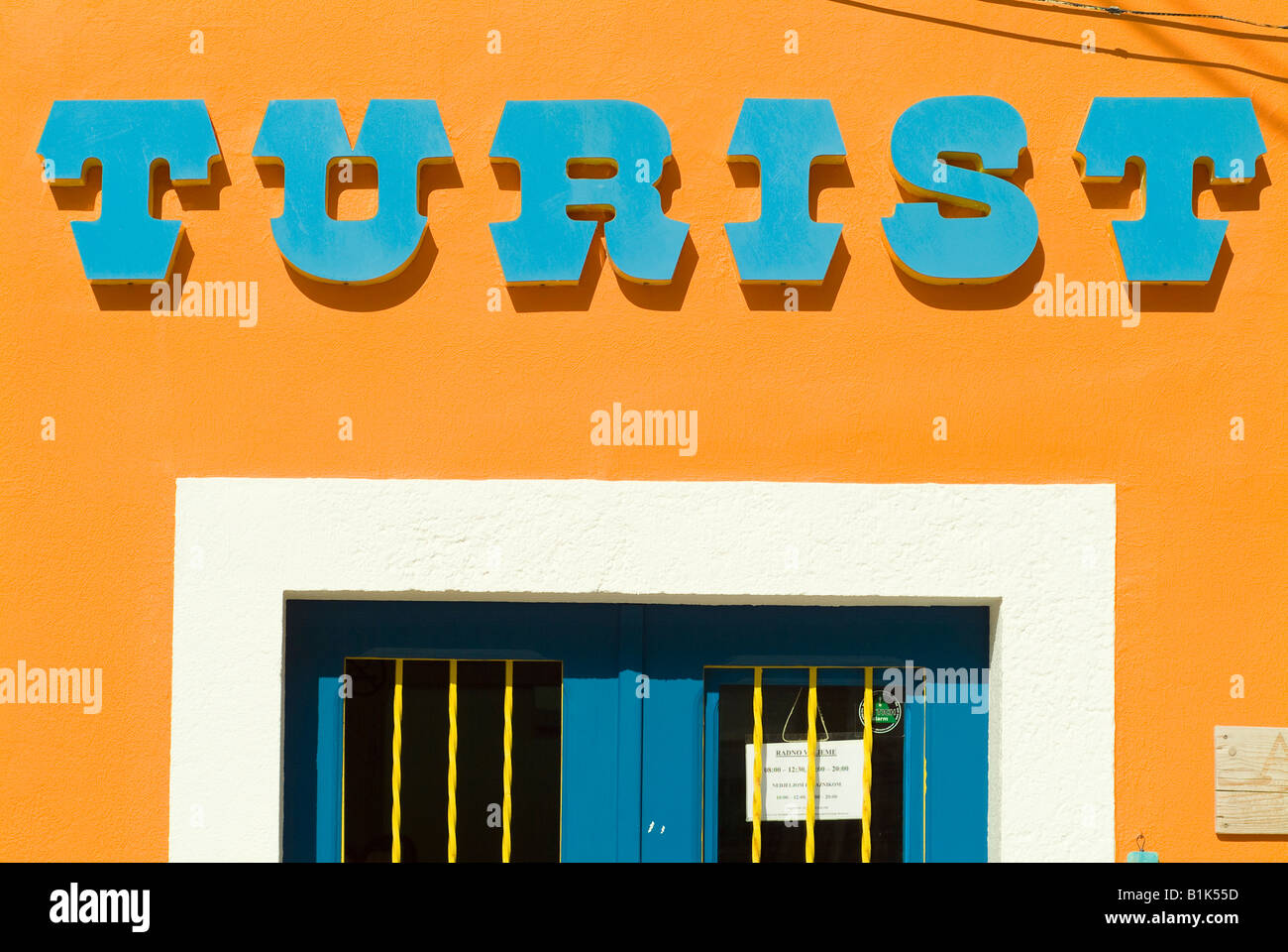 lettering script in blue letters on yellow wall turist for tourist ...