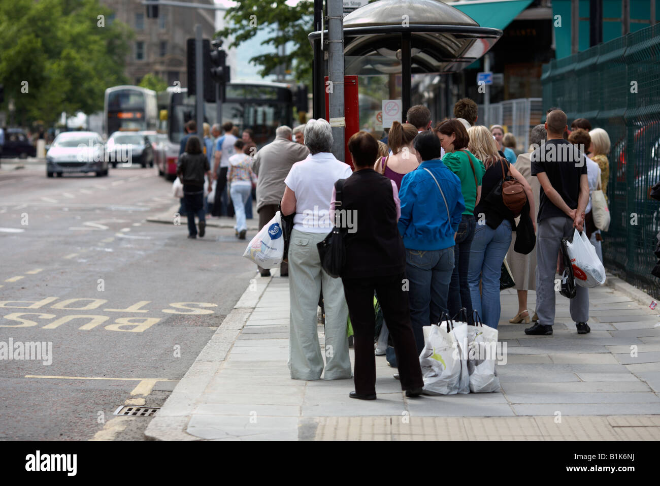 people queuing at a bus stop during saturday shopping belfast northern ...