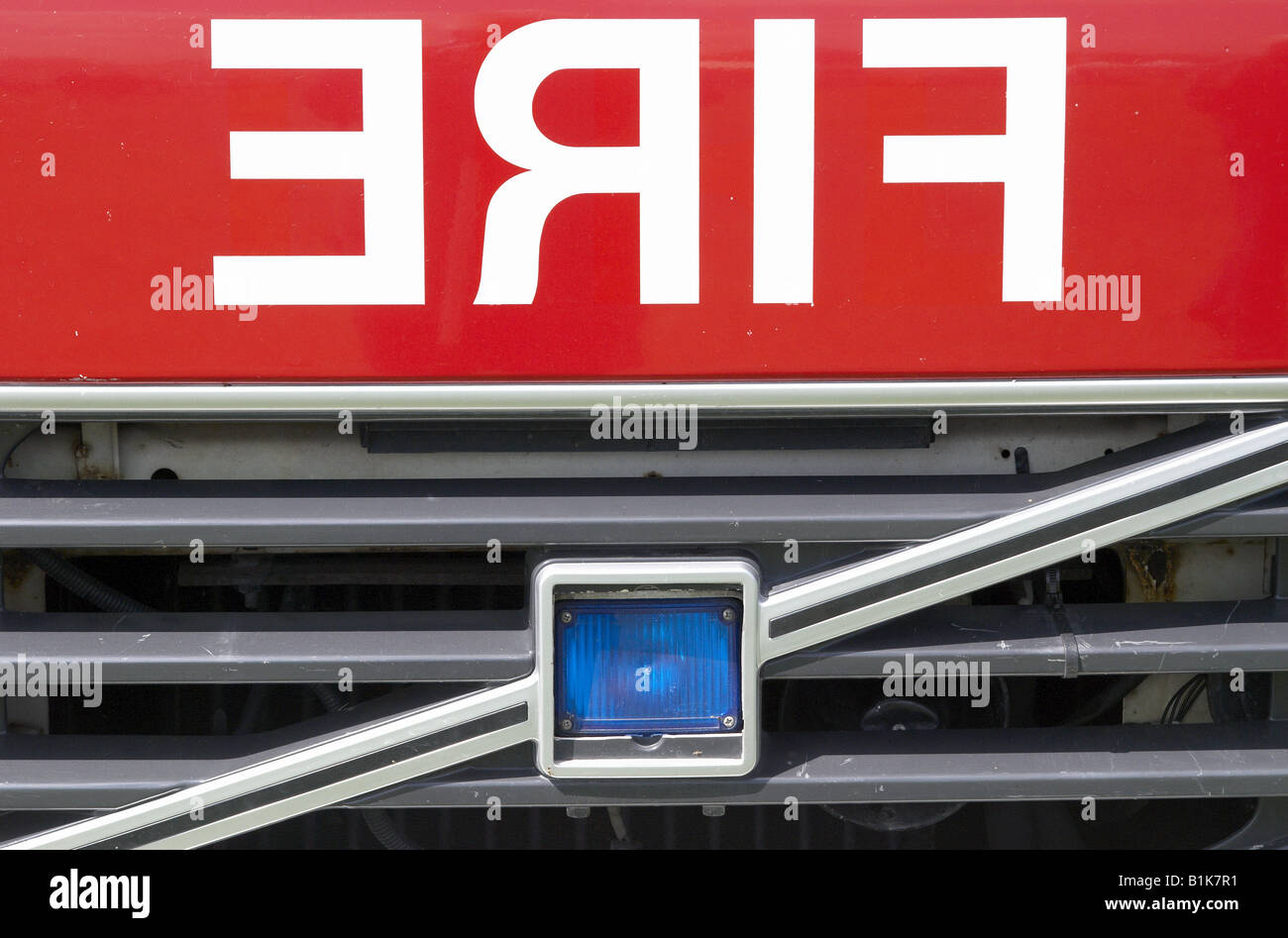 Reversed FIRE sign on the front of a British fire engine with blue ...