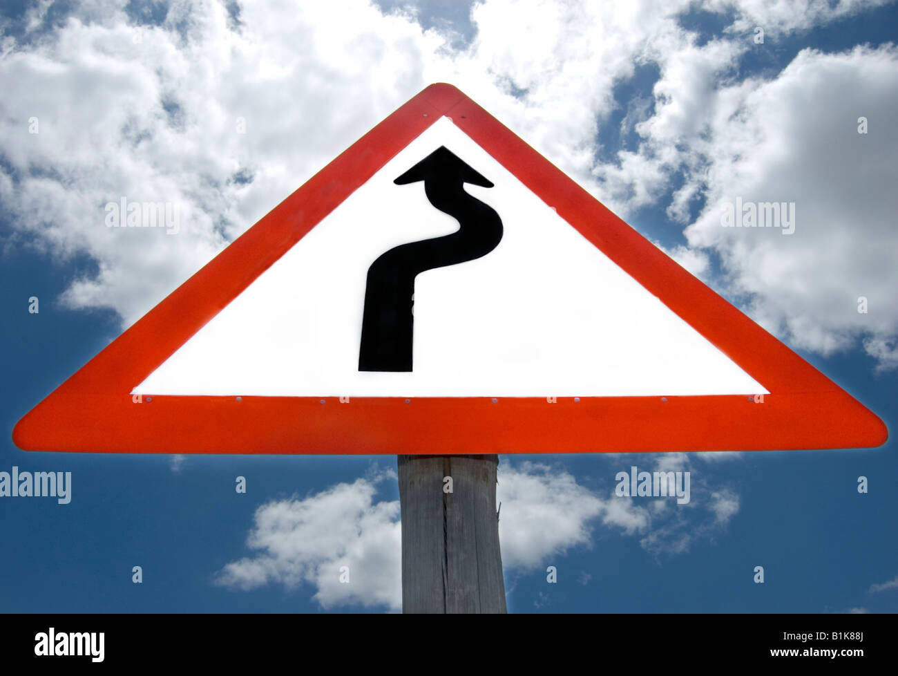 Roadside sign warning of dangerous road ahead Stock Photo - Alamy