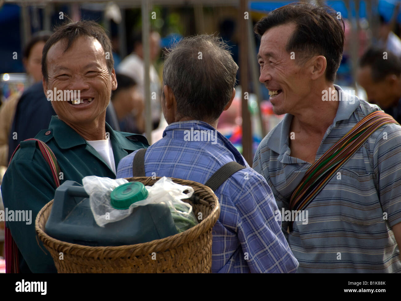 Three tribal men laughing and talking Stock Photo - Alamy