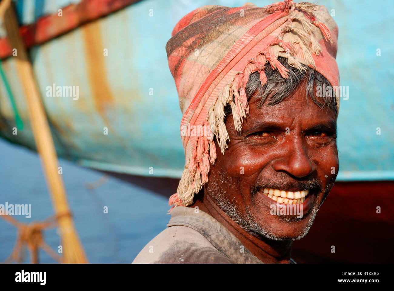 Indian fisherman wearing a head wrap smiling, portrait Stock Photo - Alamy