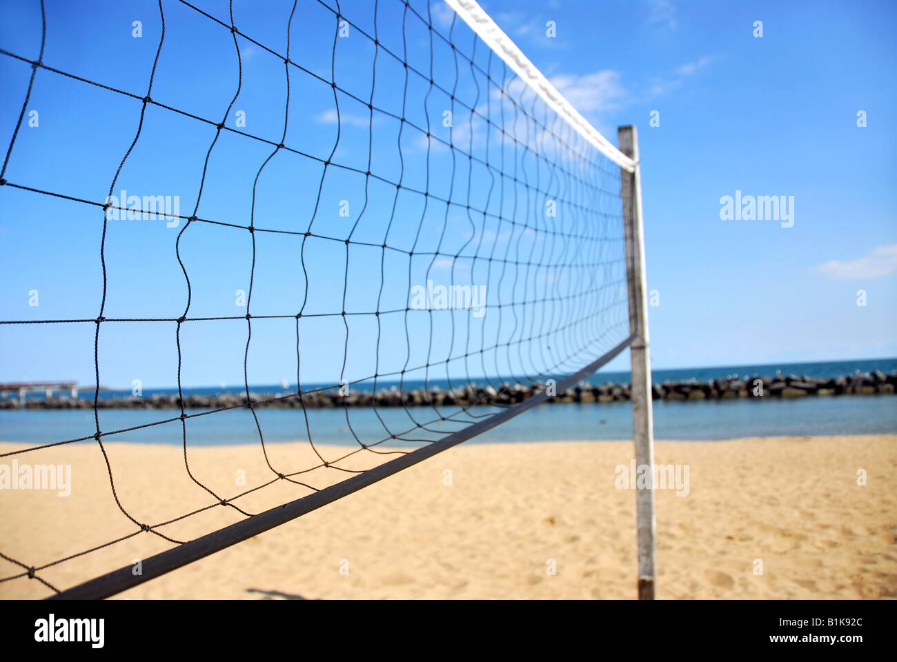 Beach volleyball net in perspective on a sandy beach Stock Photo - Alamy