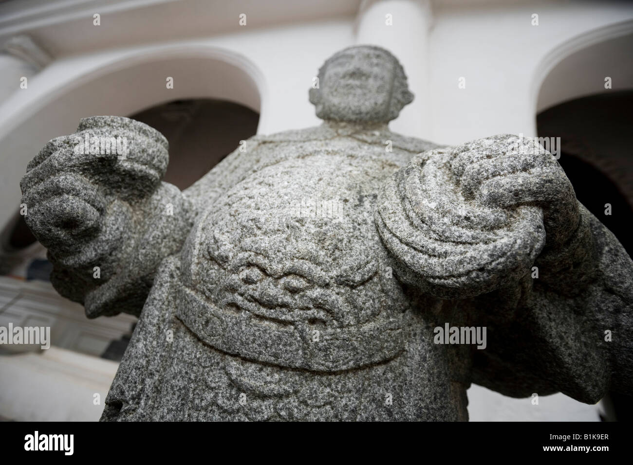 Gray statue with large belly Stock Photo - Alamy