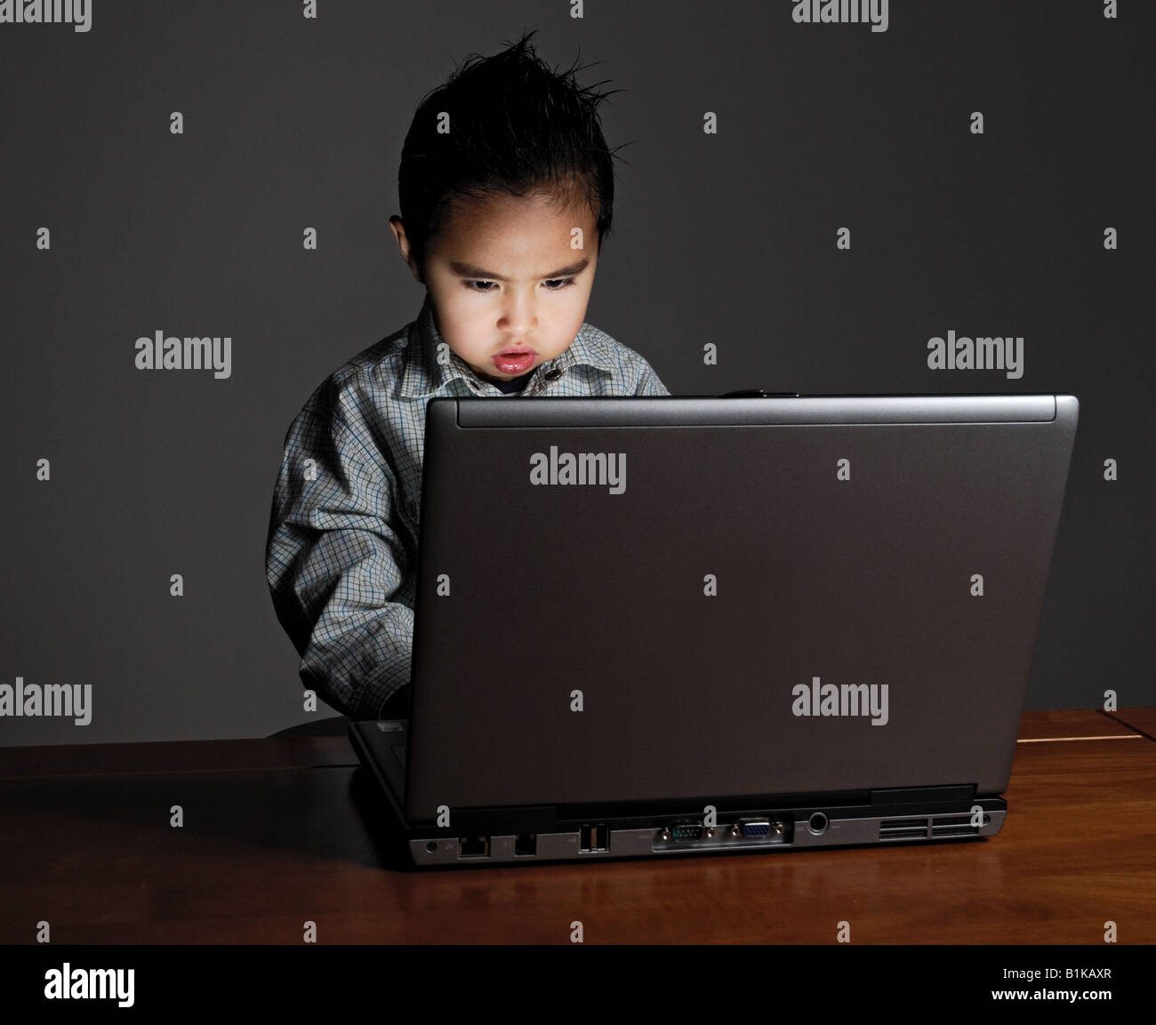 Half-asian boy using laptop Stock Photo - Alamy
